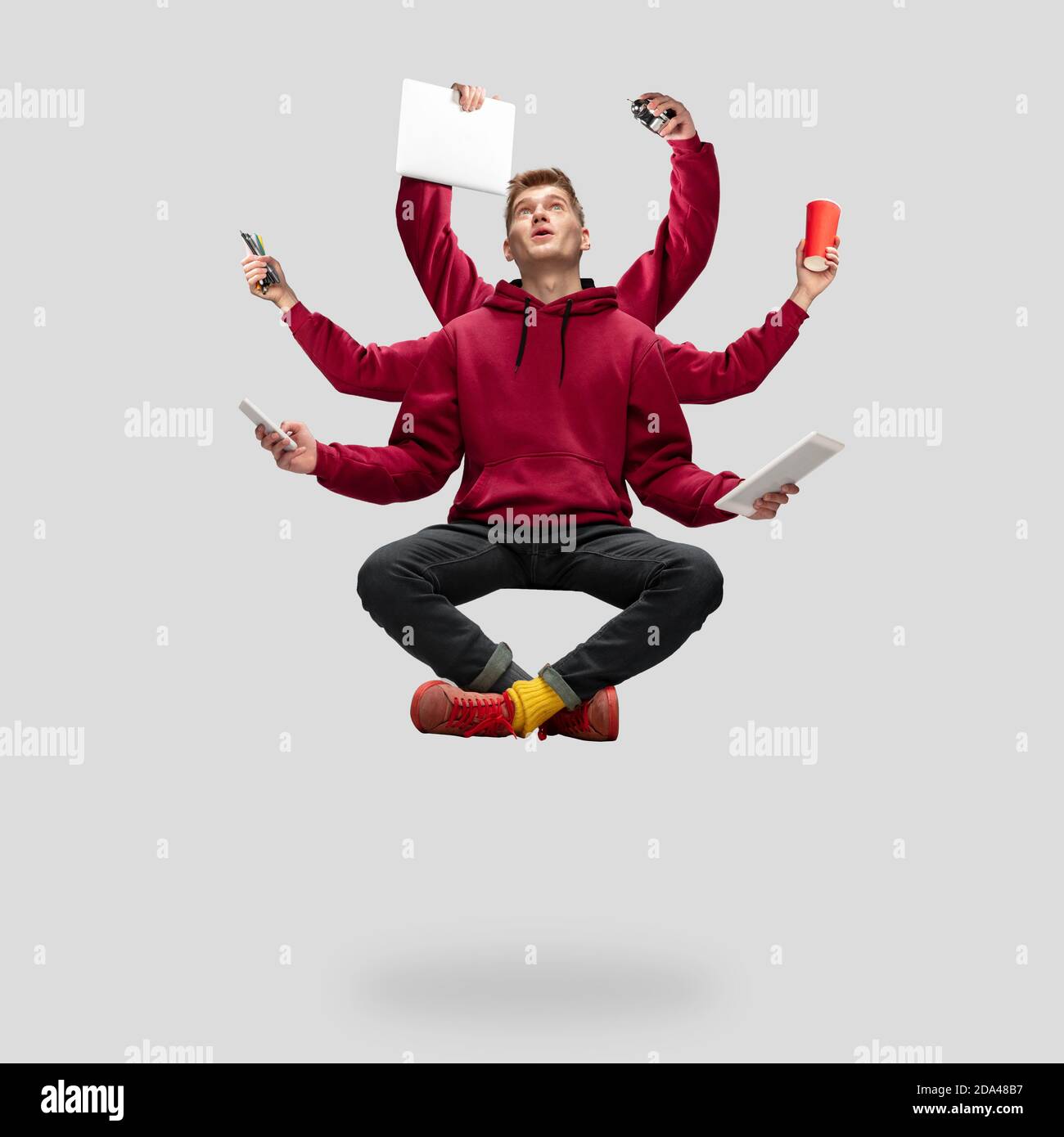Handsome student, multi-armed man levitating isolated on grey studio ...