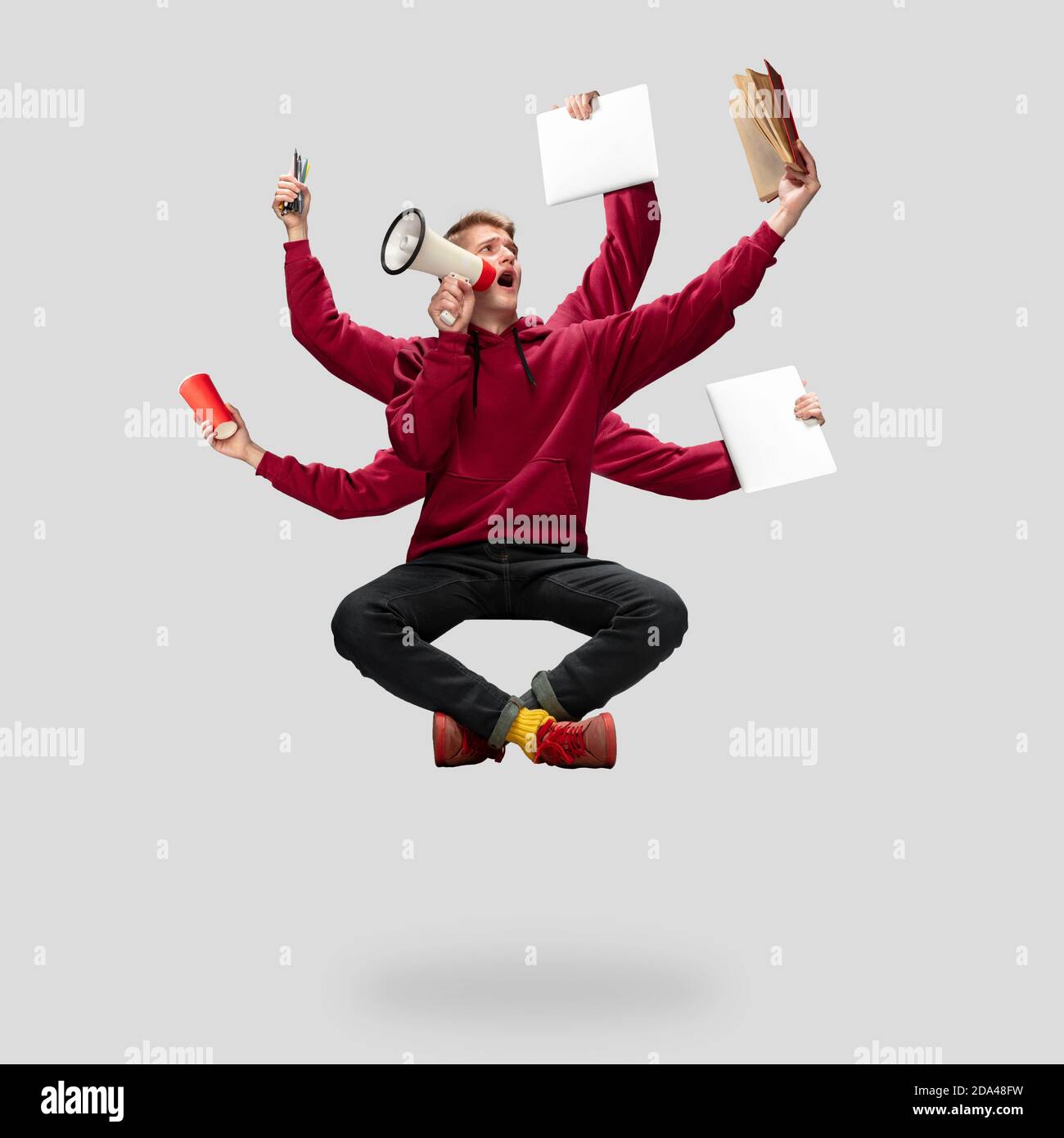 Handsome student, multi-armed man levitating isolated on grey studio ...