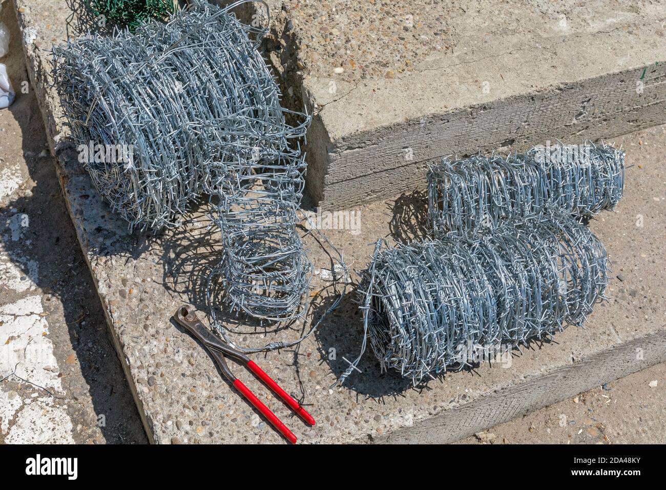 Barbed Wire in Roll and Cutters Pliers Stock Photo - Alamy