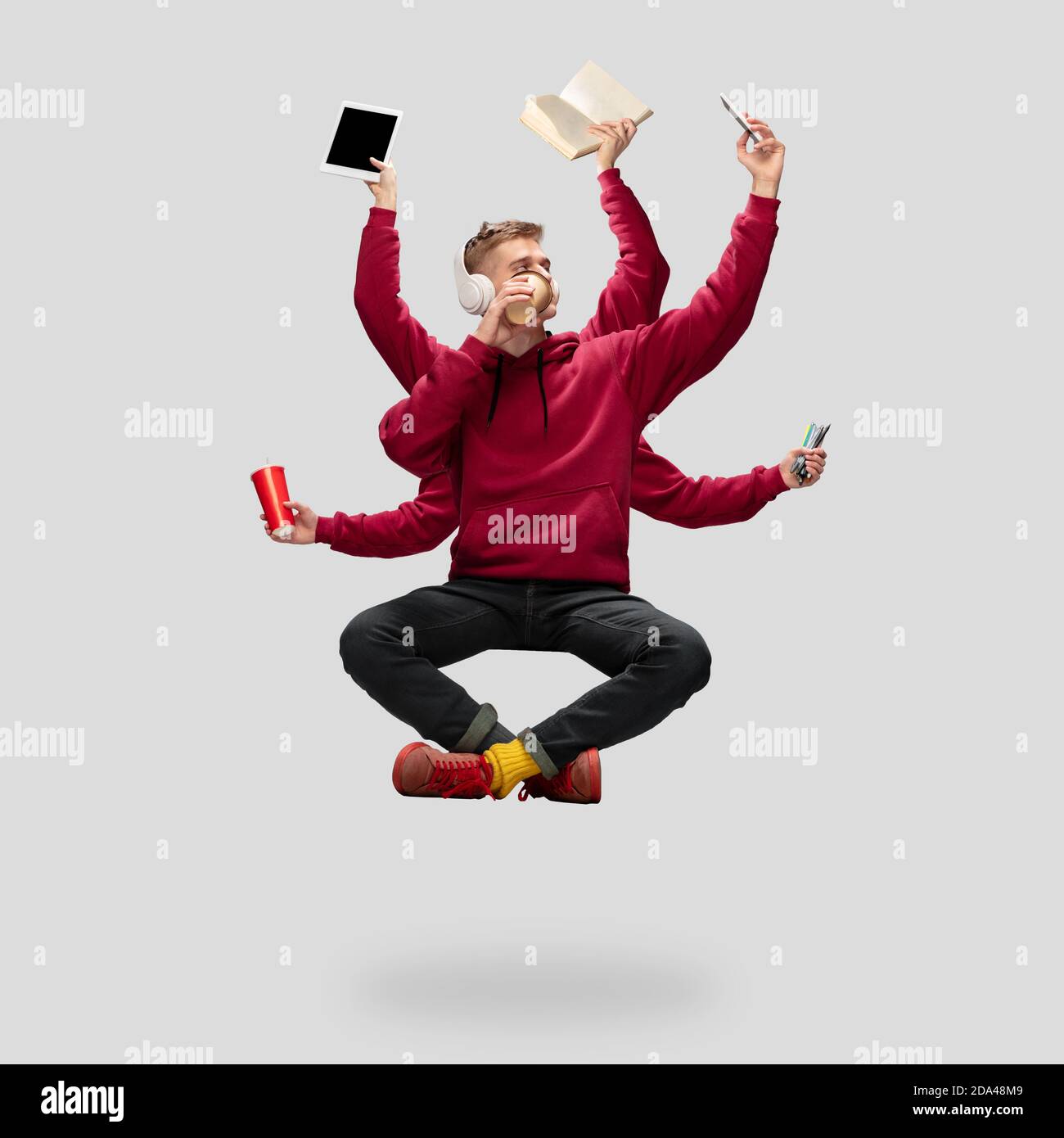 Handsome student, multi-armed man levitating isolated on grey studio ...