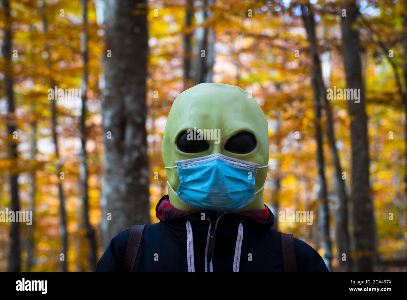 alien with surgical mask in the woods Stock Photo - Alamy