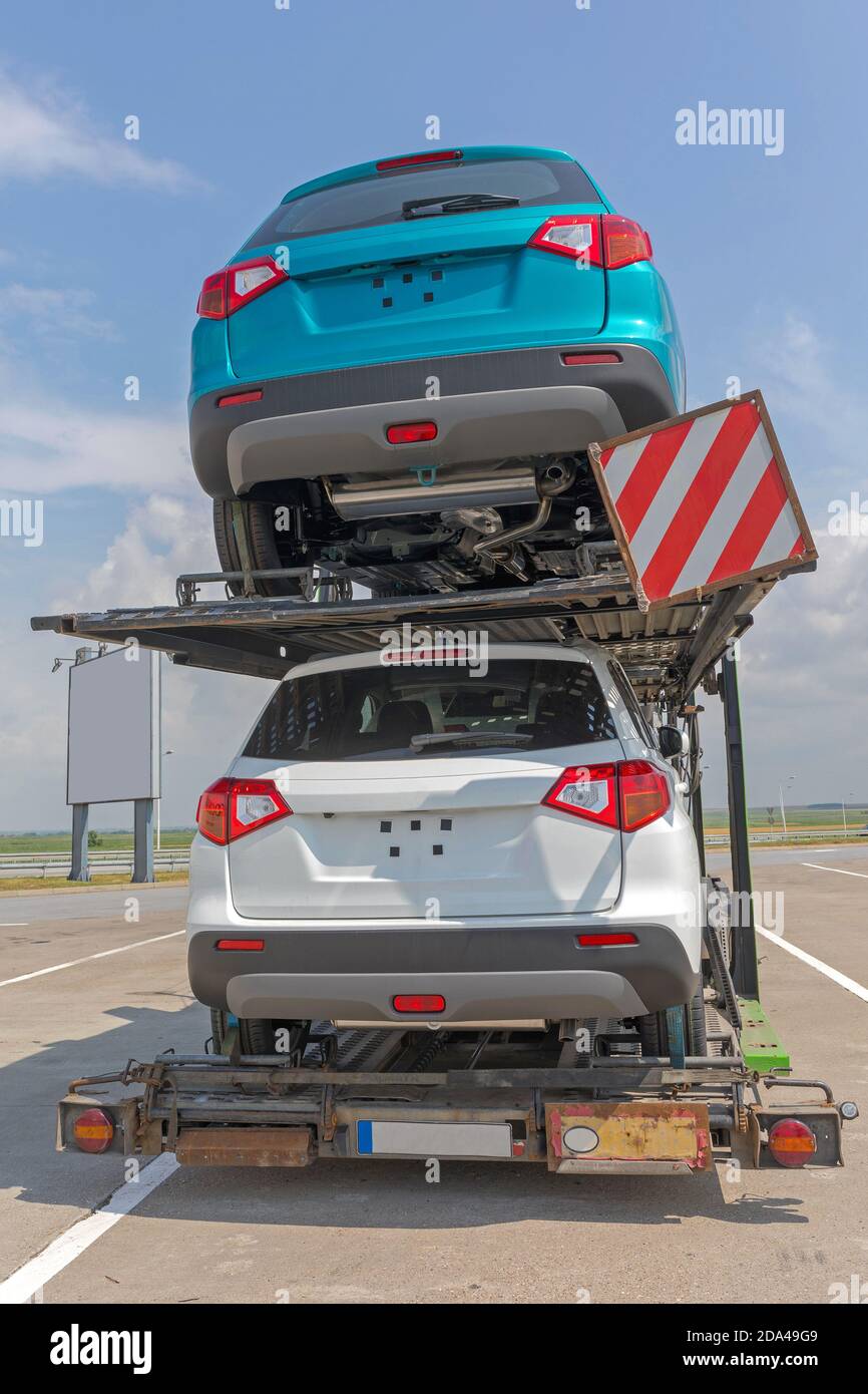 New Car Delivery Transport at Truck Trailer Stock Photo - Alamy