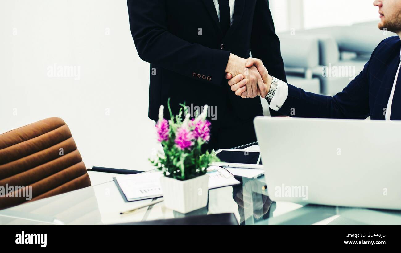 Friendly handshake between colleagues hi-res stock photography and ...