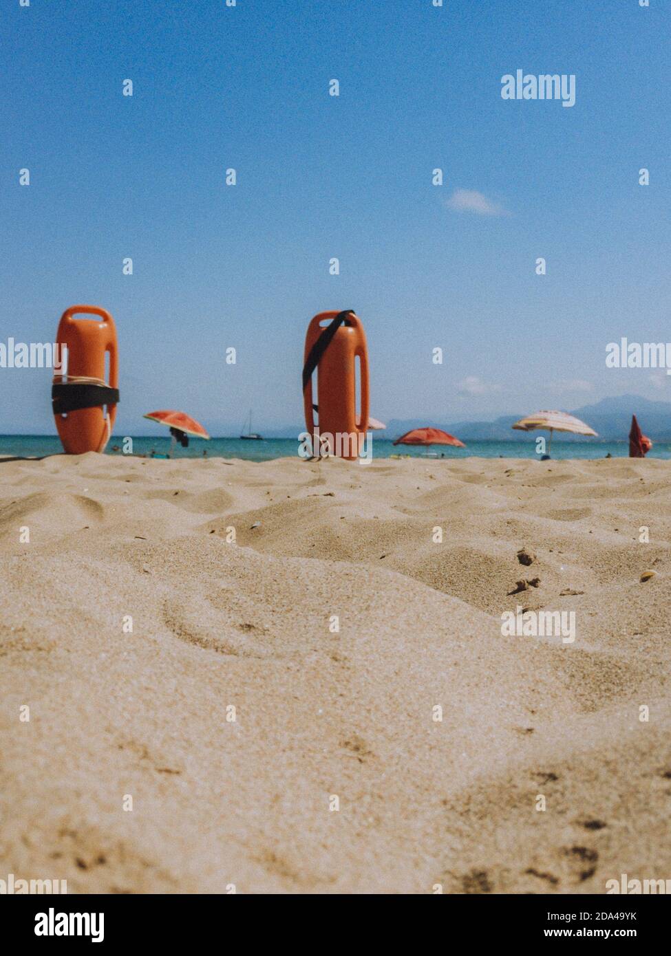 Vertical shot of lifeguard orange rescue equipment on the beach Stock ...