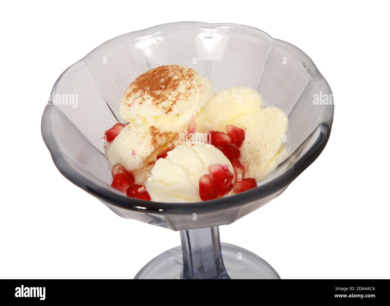 Closeup of ice cream scoops with red candy corns in a fancy cup ...