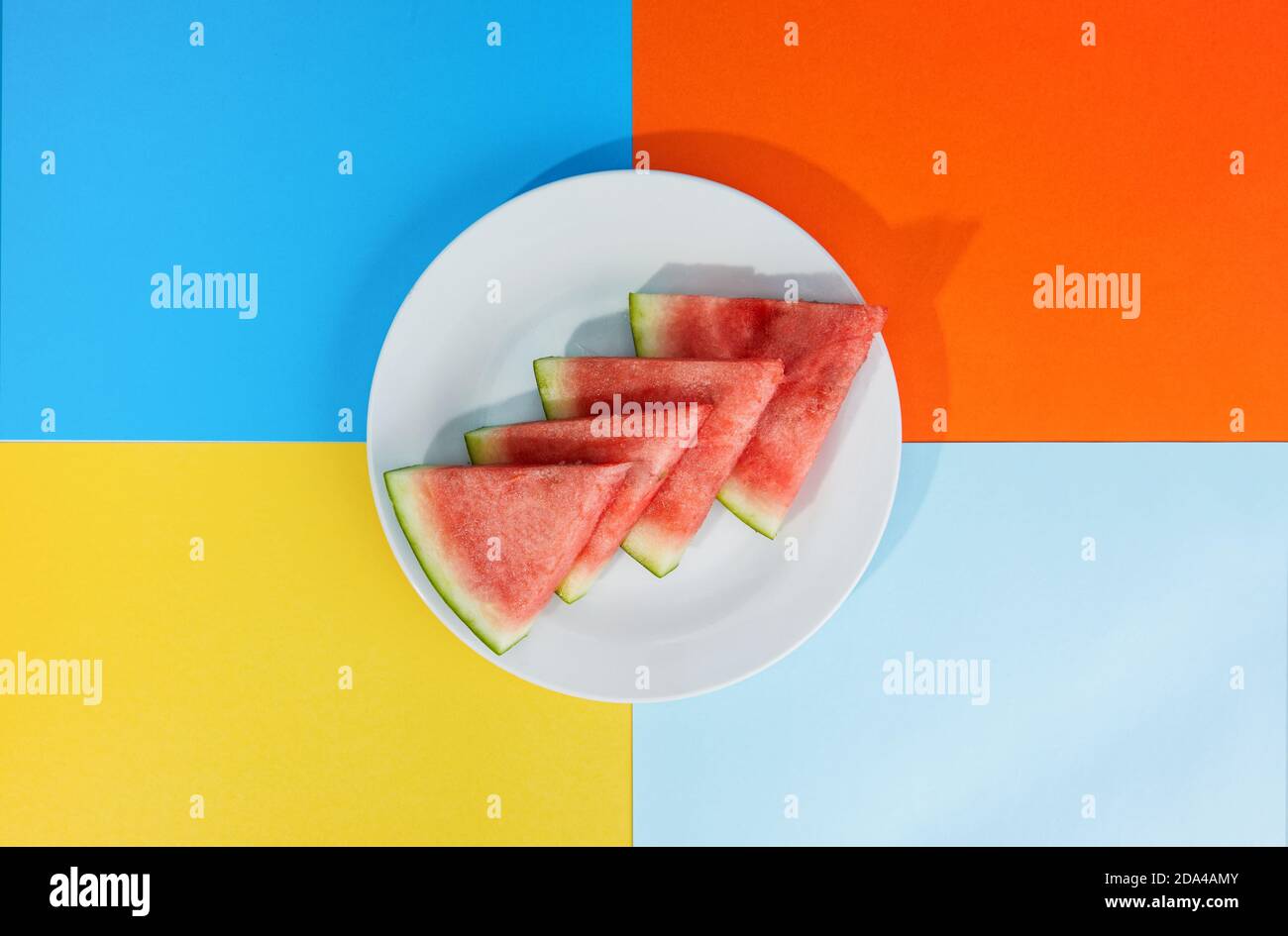 Top view of sliced watermelons on a plate against a colorful surface ...