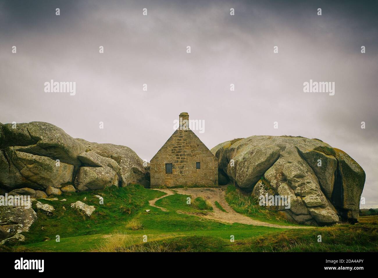 rustic house built between two large stones, france-europe Stock Photo ...