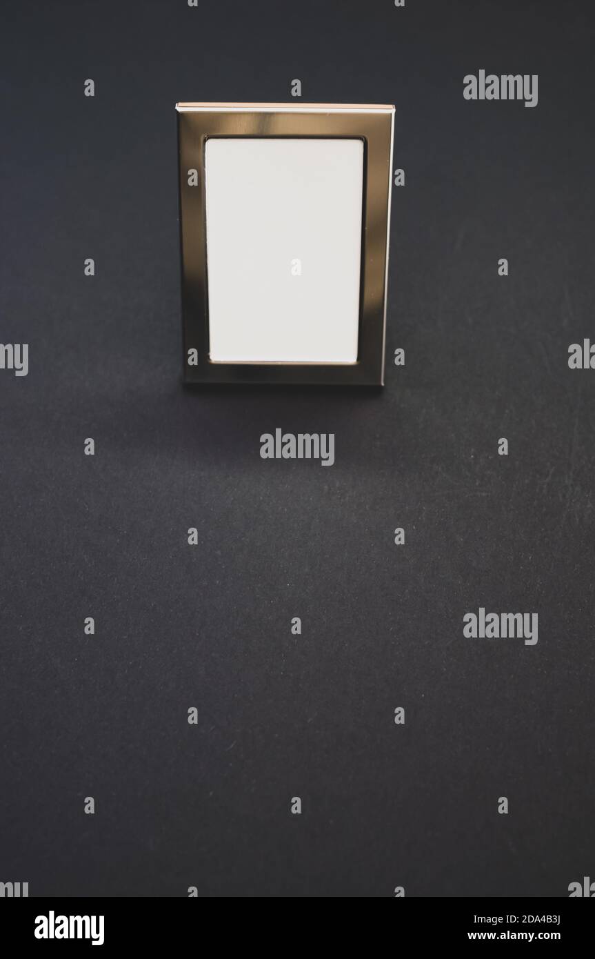 Closeup shot of a chrome picture frame isolated on a yellow background ...