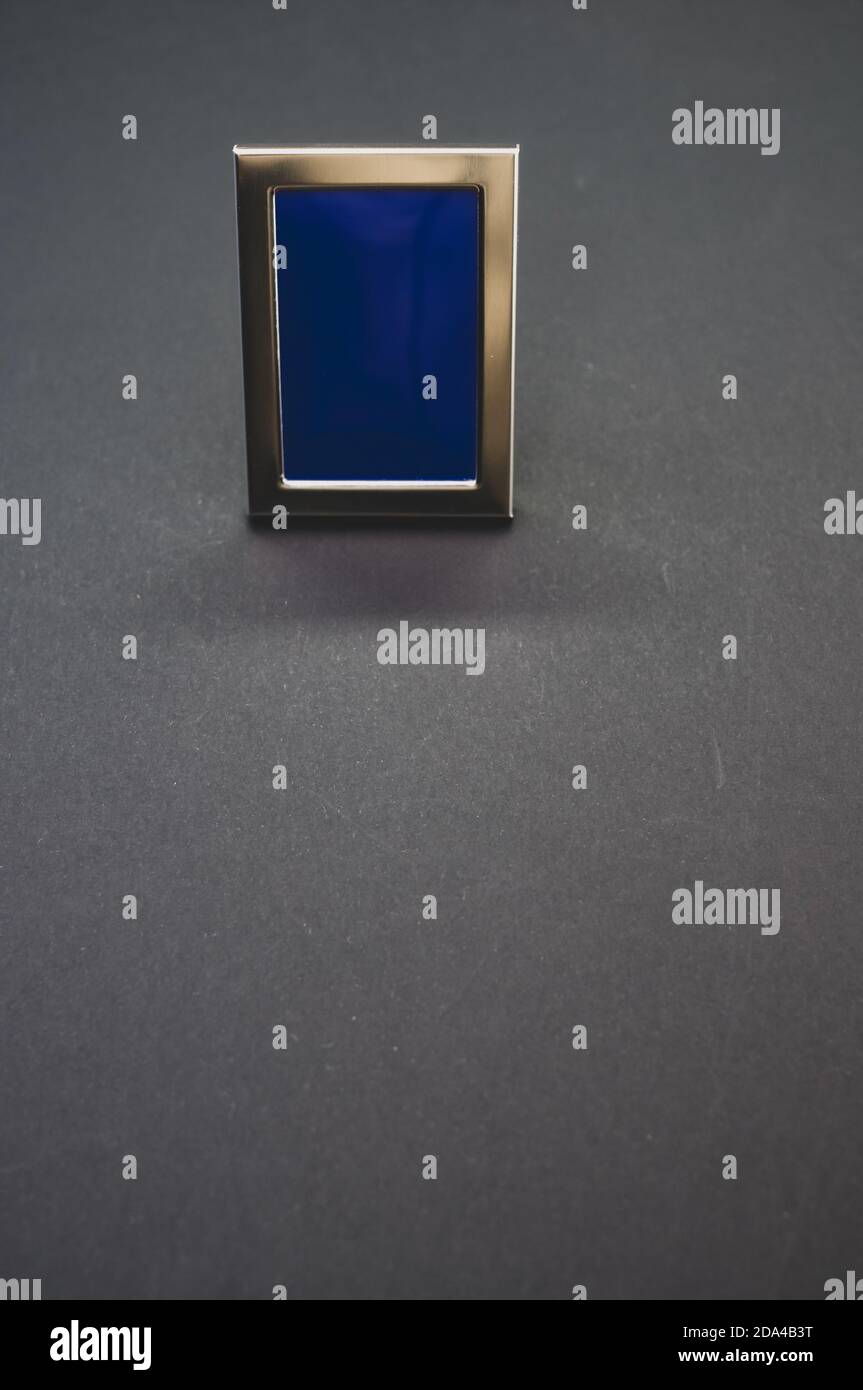 Closeup shot of a chrome picture frame isolated on a grey background ...