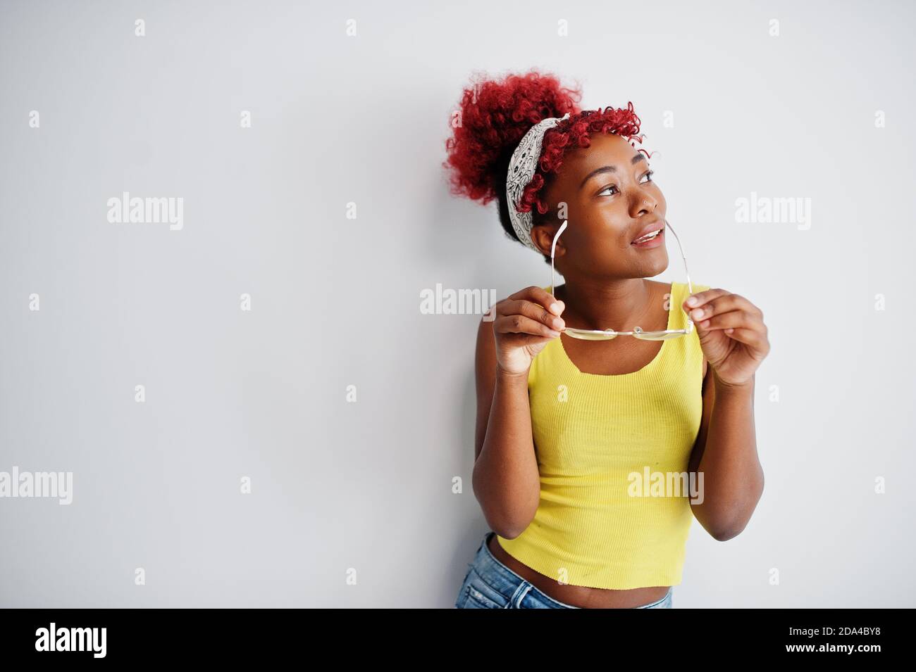 African american woman in yellow singlet and eyglasses against white ...