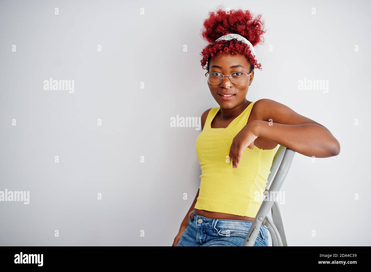 African american woman in yellow singlet and eyglasses against white ...