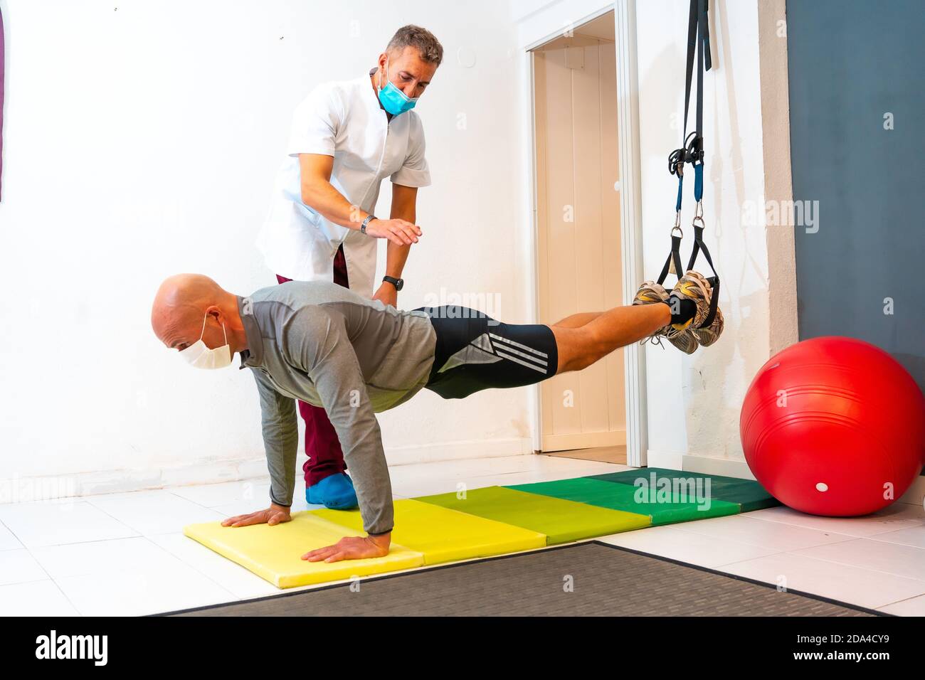 Healthcare professional guiding the patient at the rehabilitation gym ...