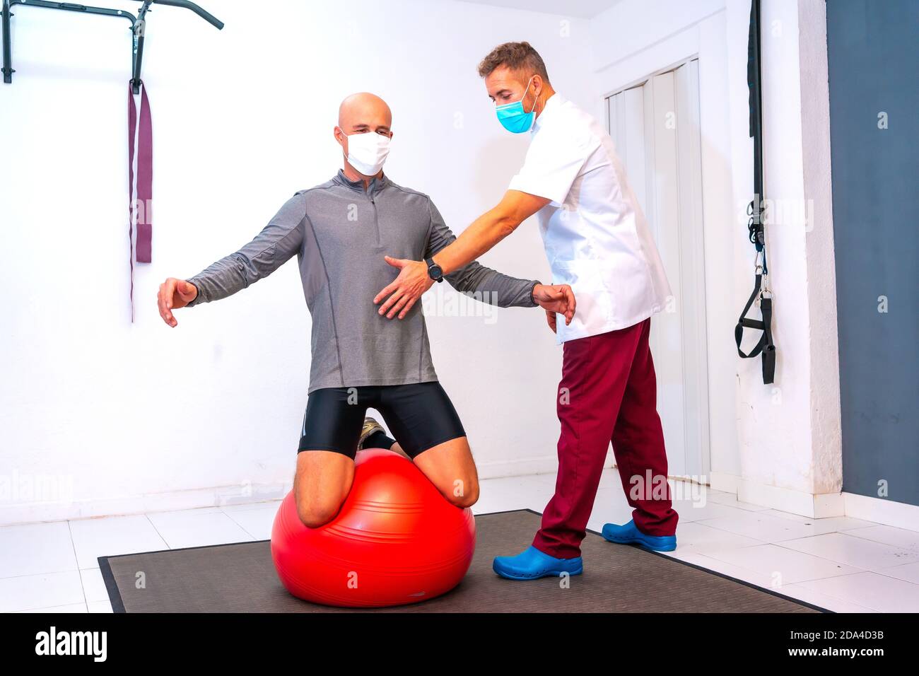 Healthcare professional guiding the patient at the rehabilitation gym ...