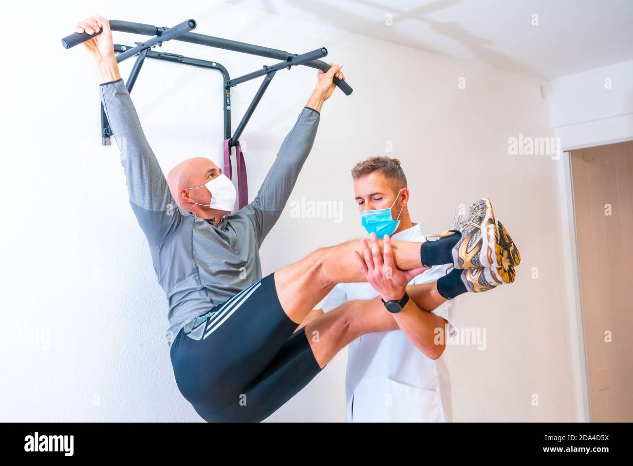 Healthcare professional guiding the patient at the rehabilitation gym ...