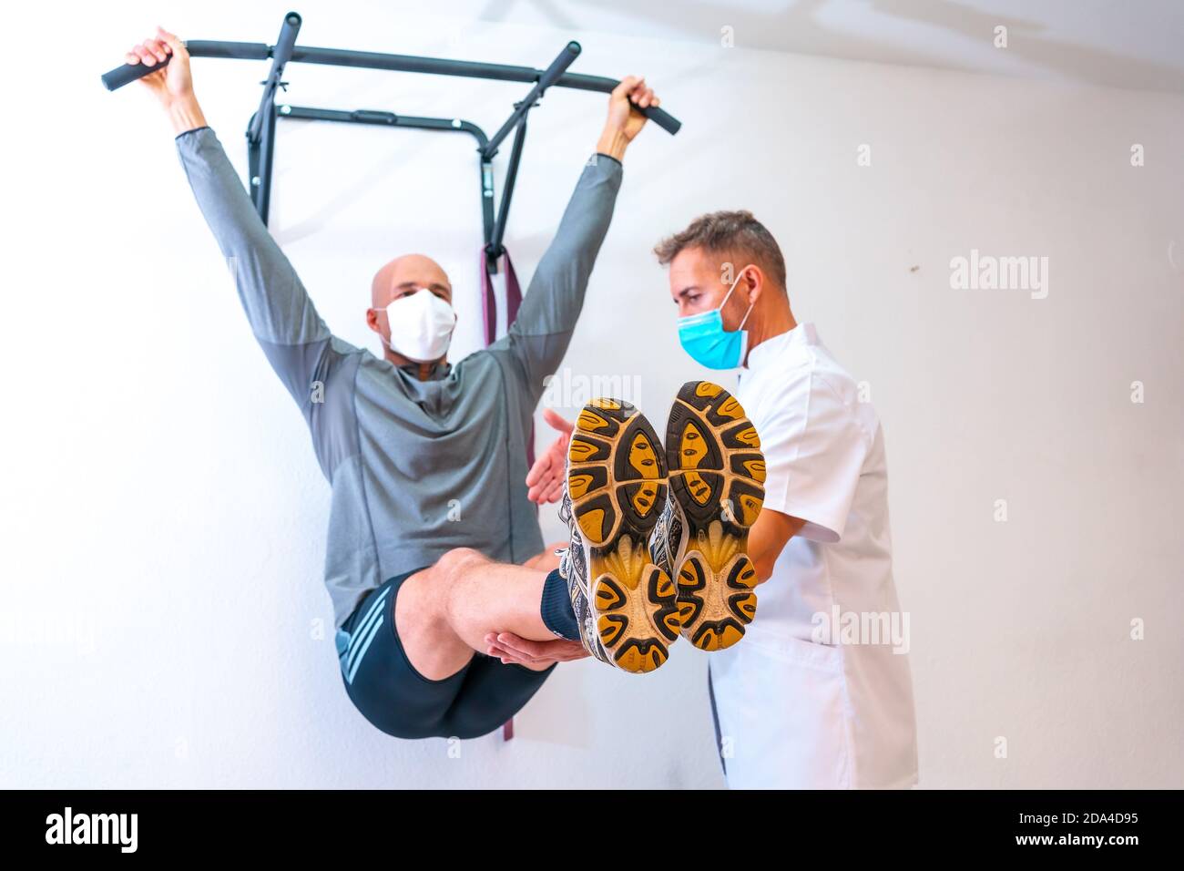 Healthcare professional guiding the patient at the rehabilitation gym ...