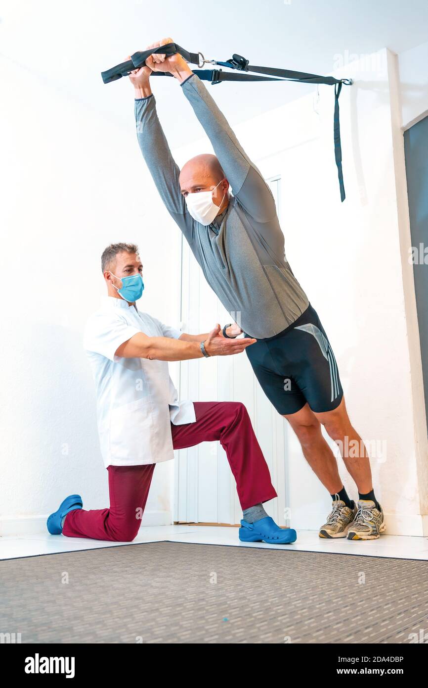 Healthcare professional guiding the patient at the rehabilitation gym ...