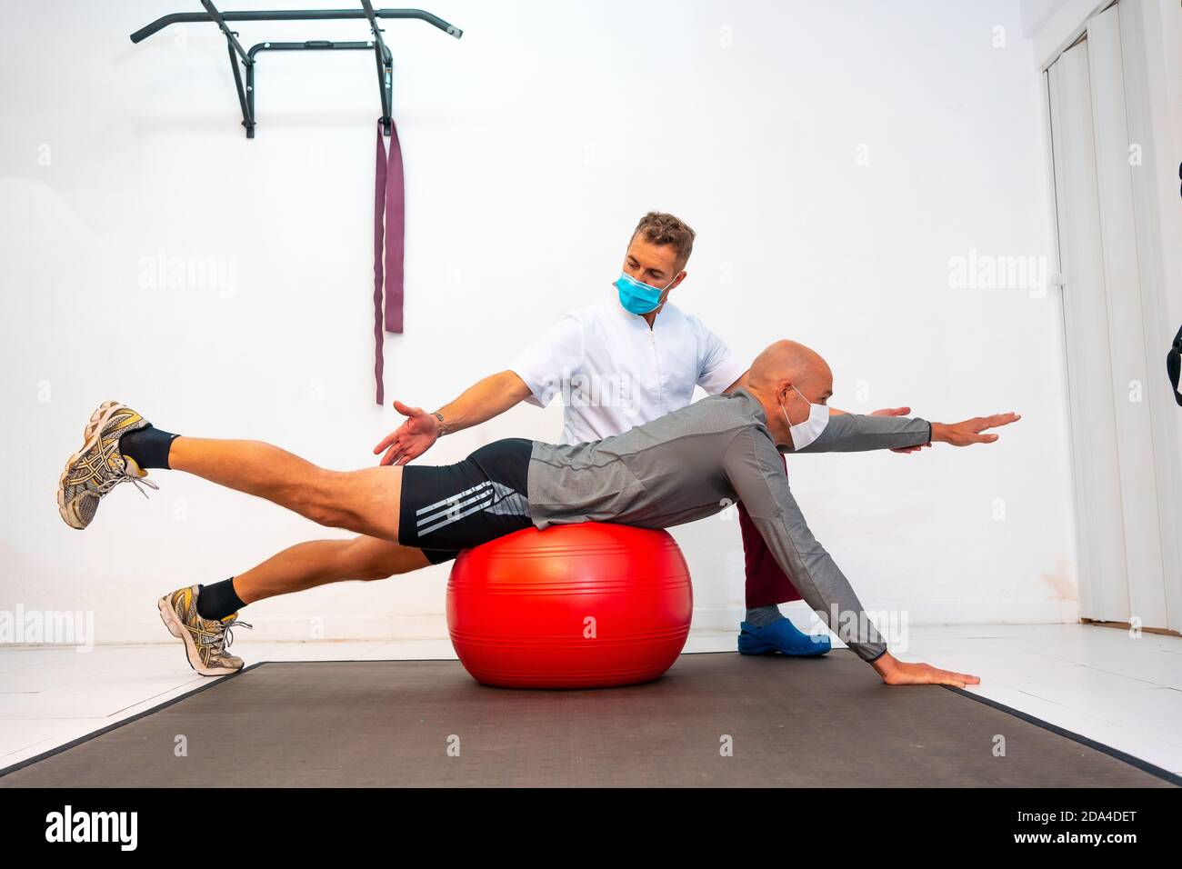 Healthcare professional guiding the patient at the rehabilitation gym ...