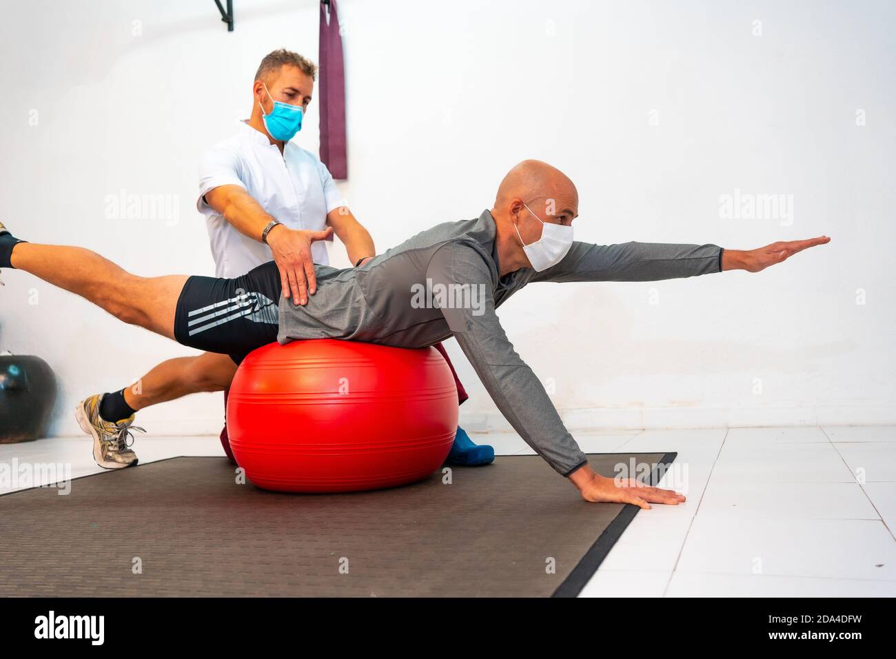 Healthcare professional guiding the patient at the rehabilitation gym ...
