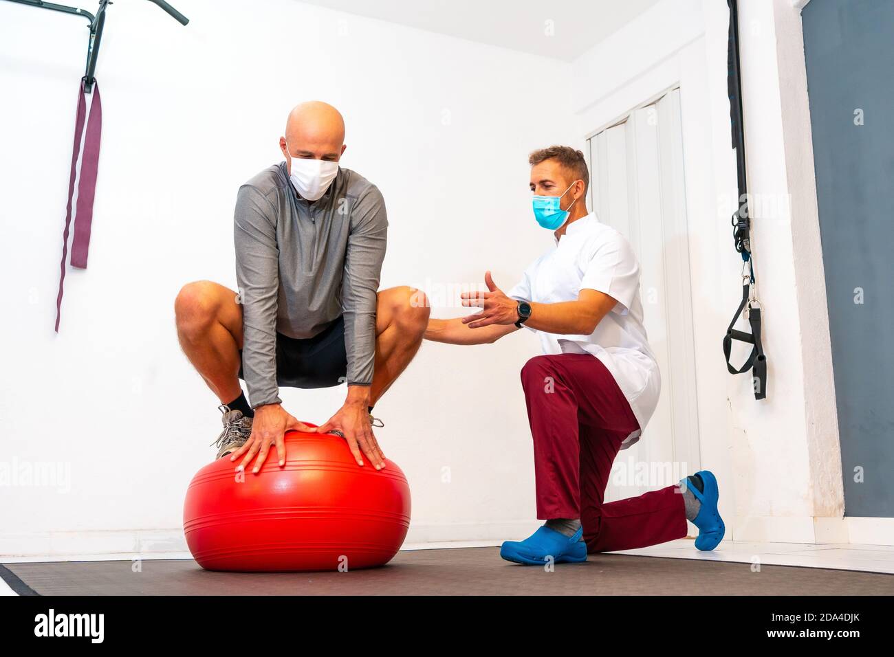 Healthcare professional guiding the patient at the rehabilitation gym ...