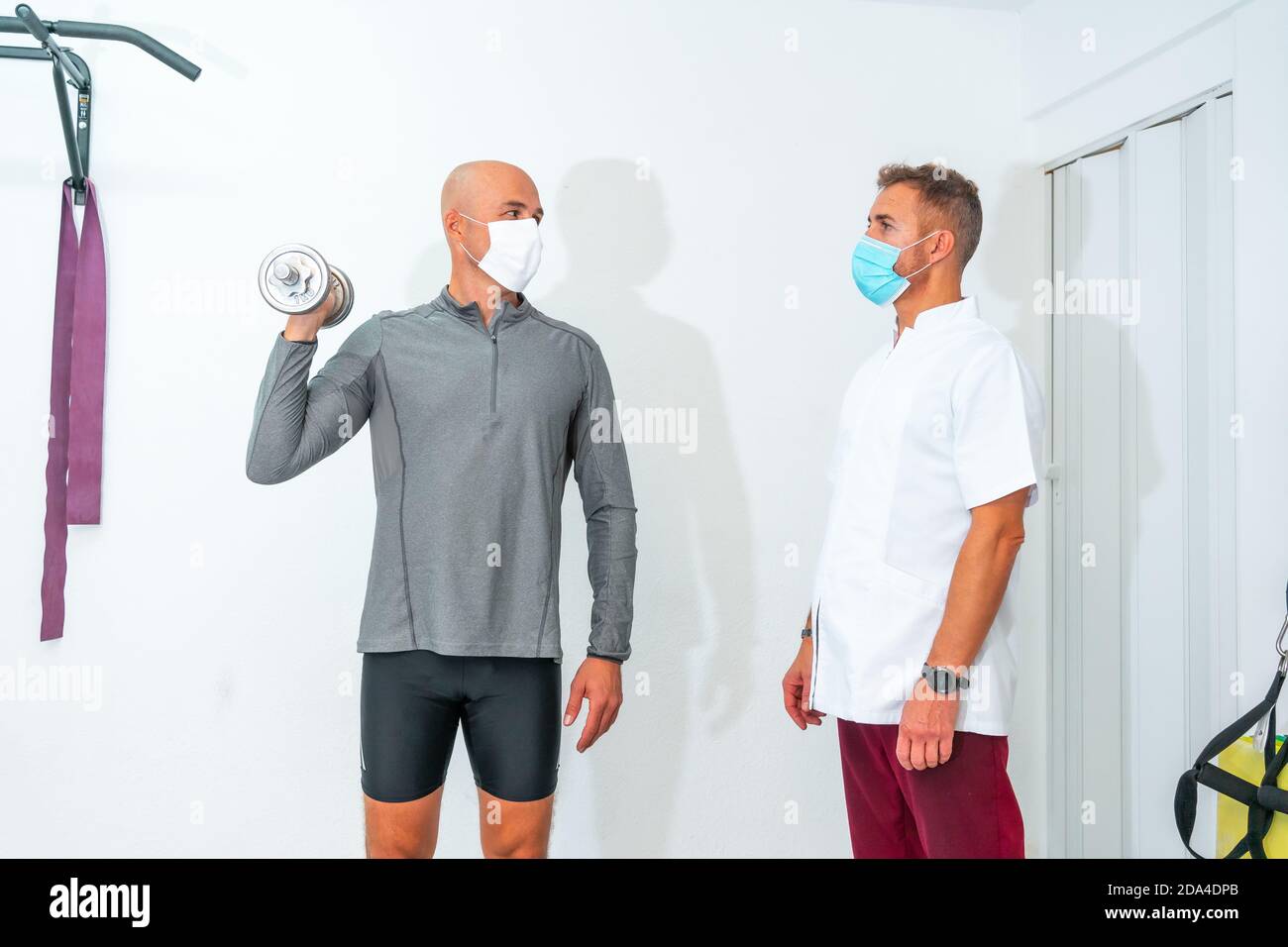Healthcare professional guiding the patient at the rehabilitation gym ...