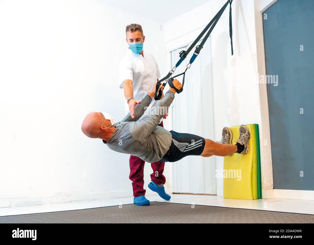 Healthcare professional guiding the patient at the rehabilitation gym ...