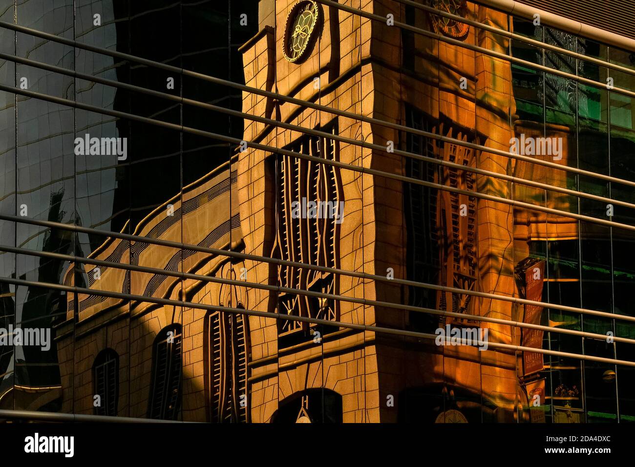 Reflective cladding on the lower floors of an office tower bends and ...