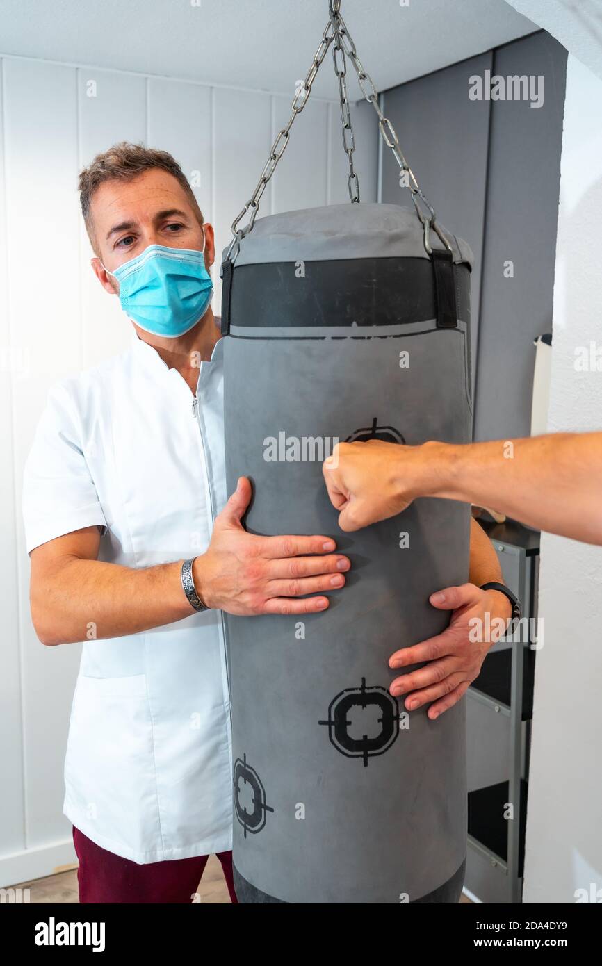 Healthcare professional guiding the patient at the rehabilitation gym ...