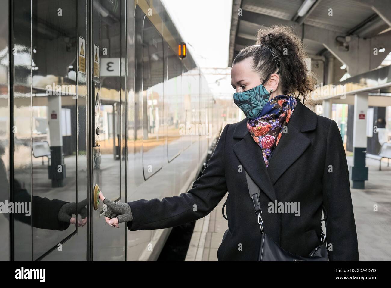 female passenger wearing face covering mask during covid-19 lockdown ...