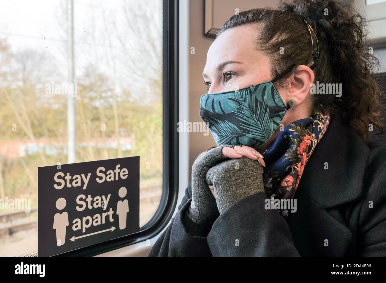 female passenger wearing face covering mask during covid-19 lockdown ...