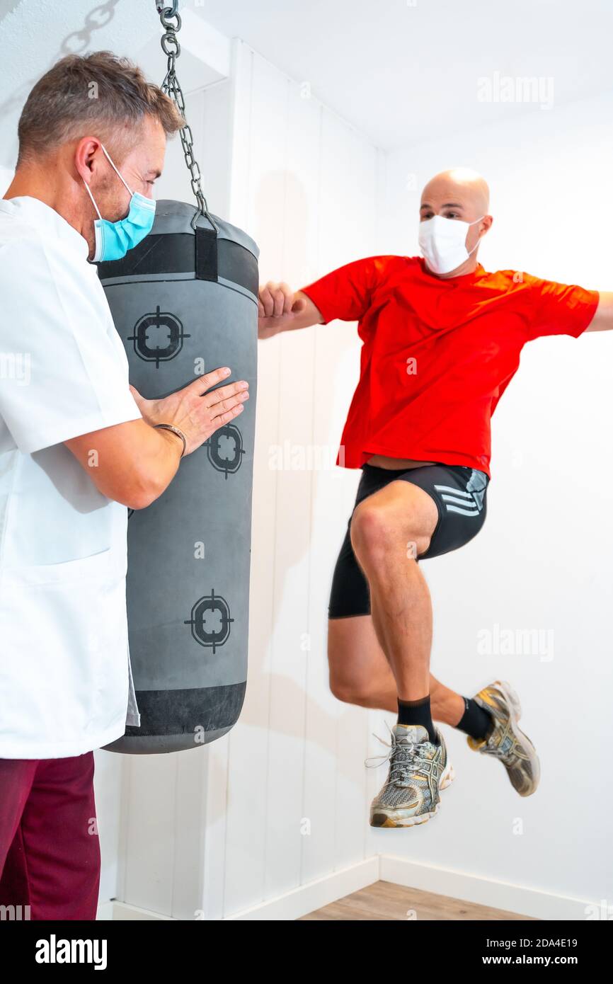 Healthcare professional guiding the patient at the rehabilitation gym ...