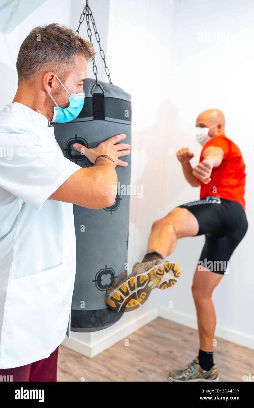 Healthcare professional guiding the patient at the rehabilitation gym ...