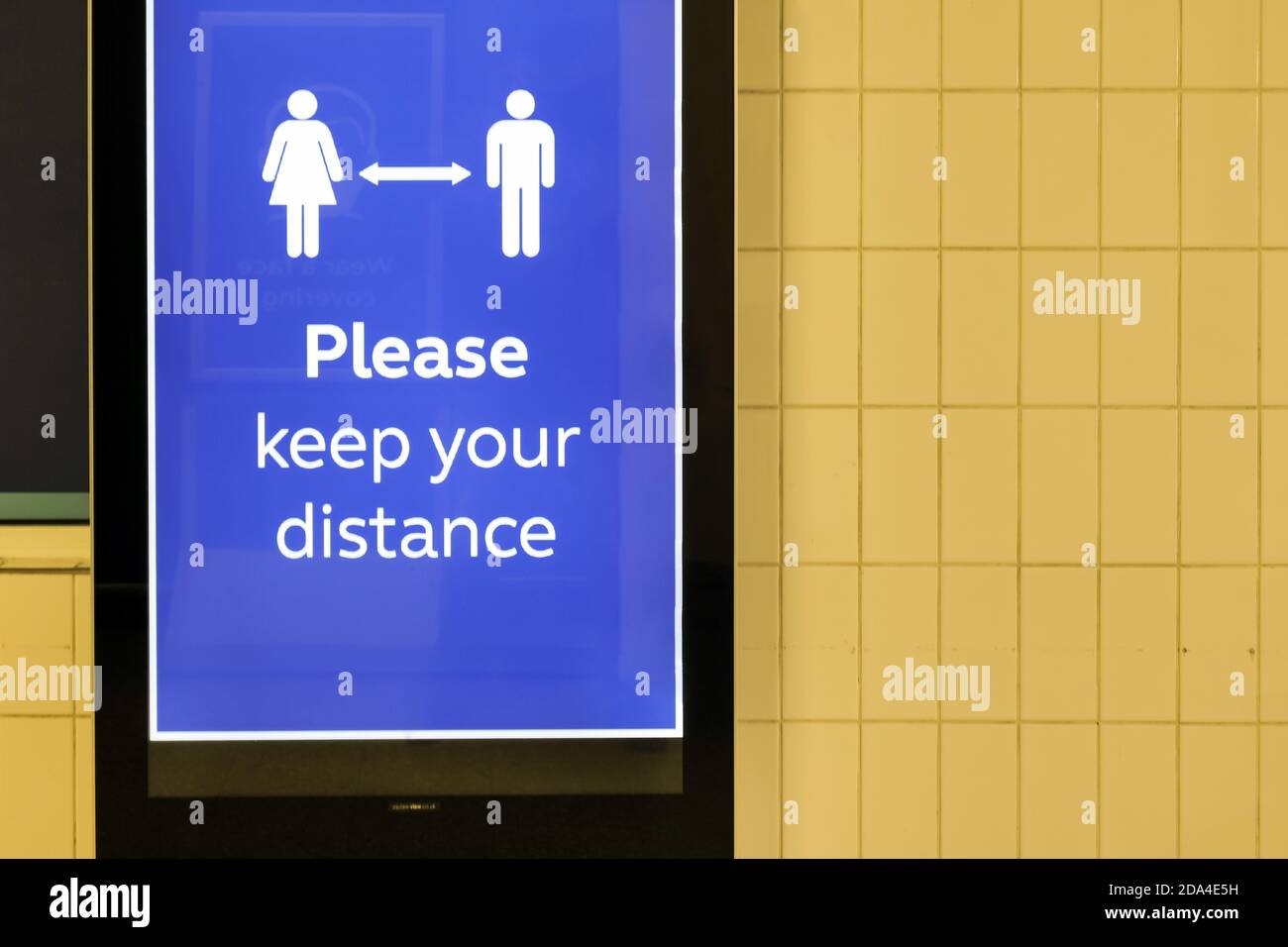 please keep your distance message on digital display on train station ...
