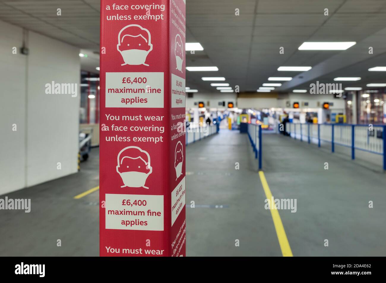 wear face covering poster on digital display on train station during ...