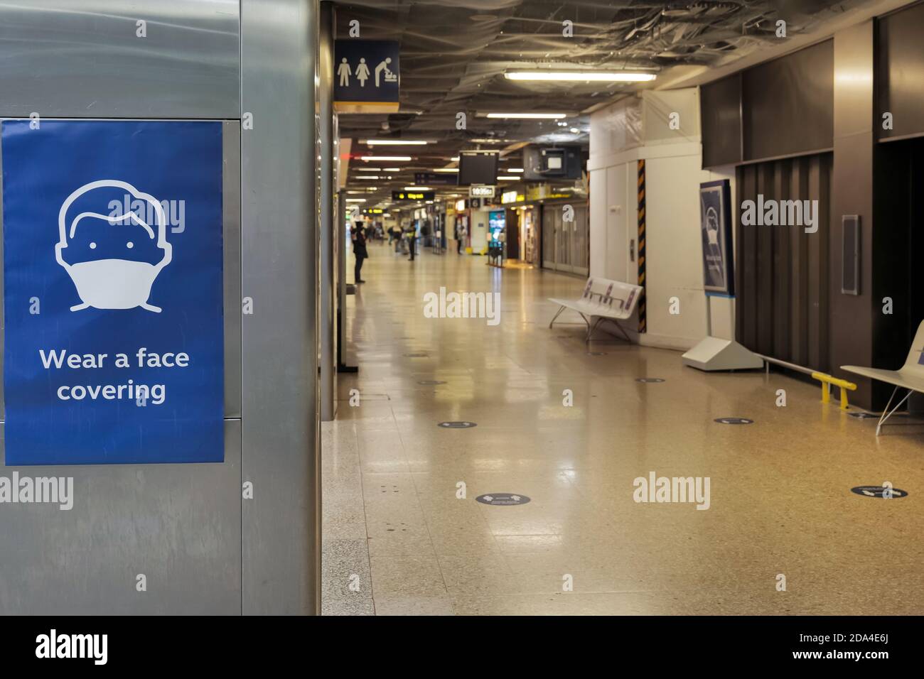 wear face covering poster on digital display on train station during ...