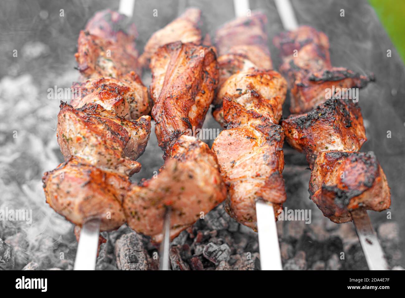 The barbecue is grilled on the grill. Meat or shish kebab on the fire ...