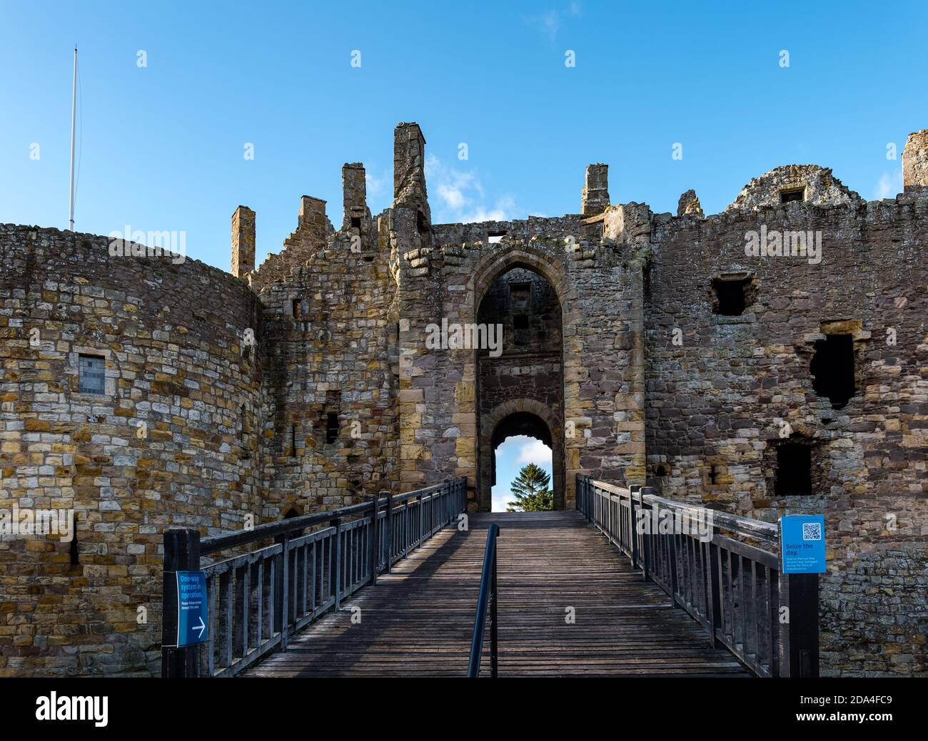 Drawbridge entrance over moat of ruined Medieval Dirleton Castle during ...