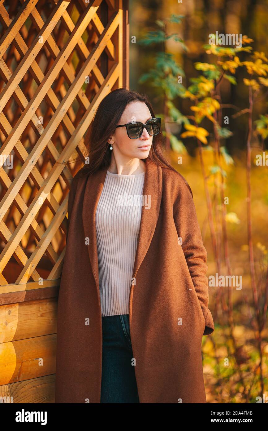 Beautiful woman in autumn park under fall foliage Stock Photo - Alamy