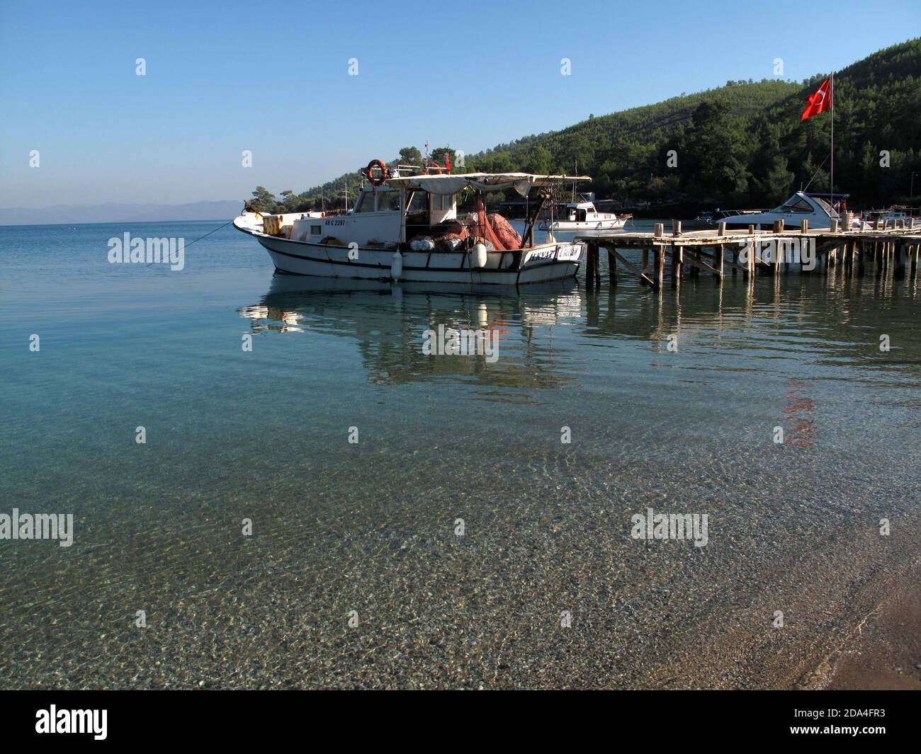 Boats at a jetty in a small Turkish fishing village Stock Photo - Alamy