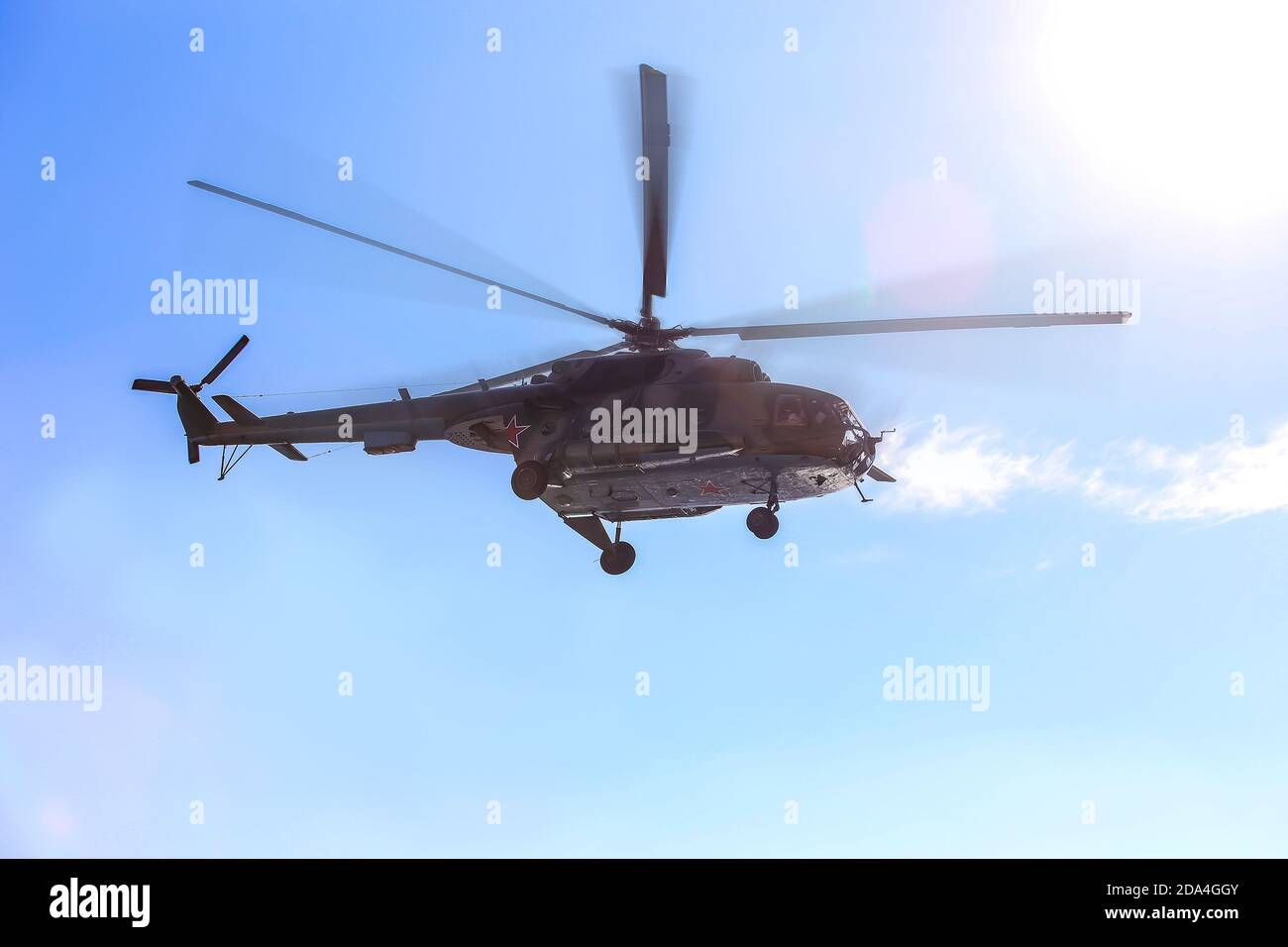 Russian military helicopter flies in the blue sky Stock Photo - Alamy