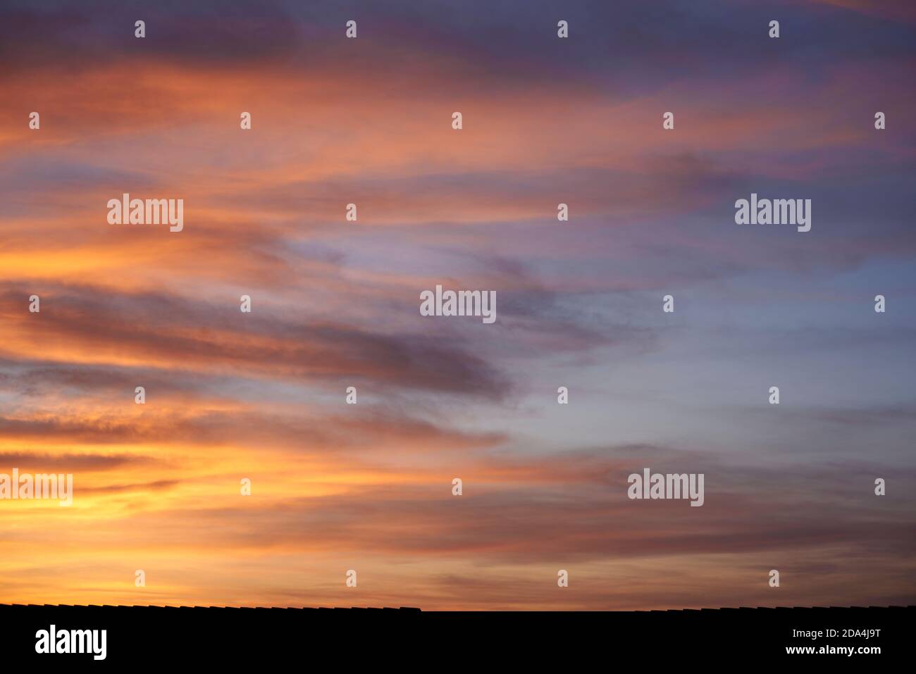 Sunset. Heaven, orange sky. Sun rays. Wallpaper. Clouds Stock Photo - Alamy