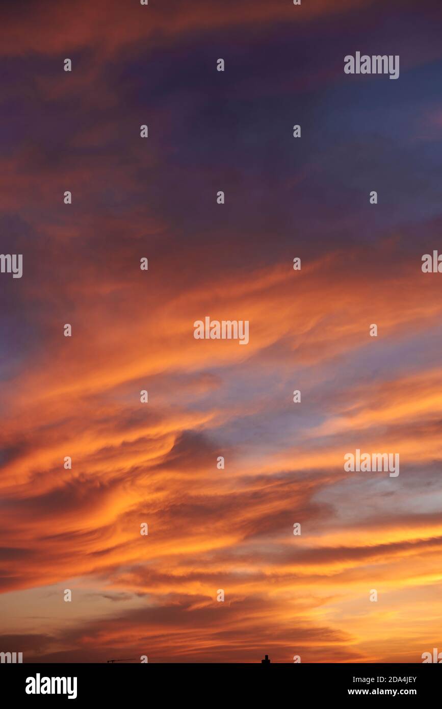 Sunset. Heaven, orange sky. Sun rays. Wallpaper. Clouds Stock Photo - Alamy