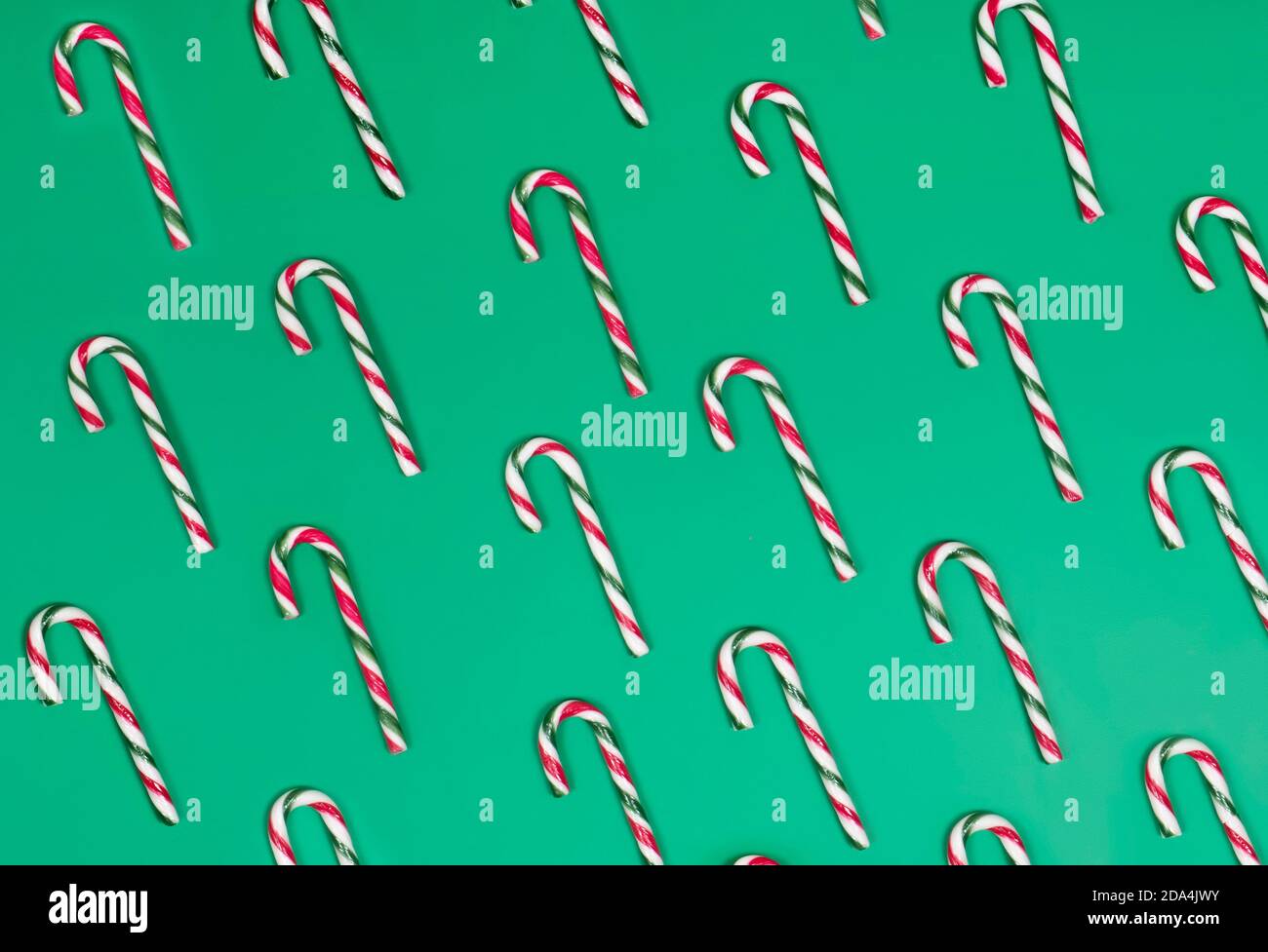 Candy canes on the green background Stock Photo - Alamy