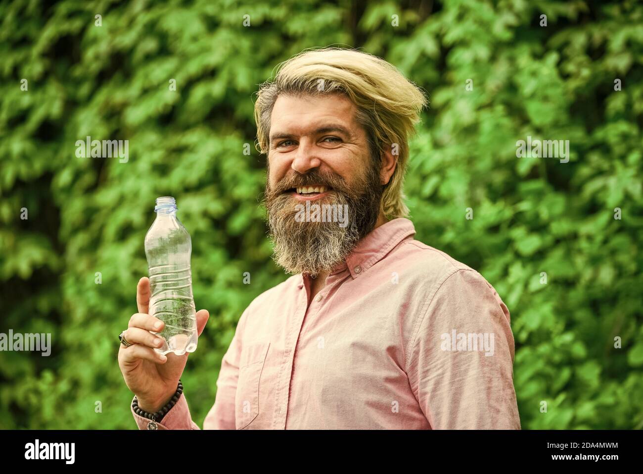 Water balance. Man bearded tourist drinking water plastic bottle nature ...