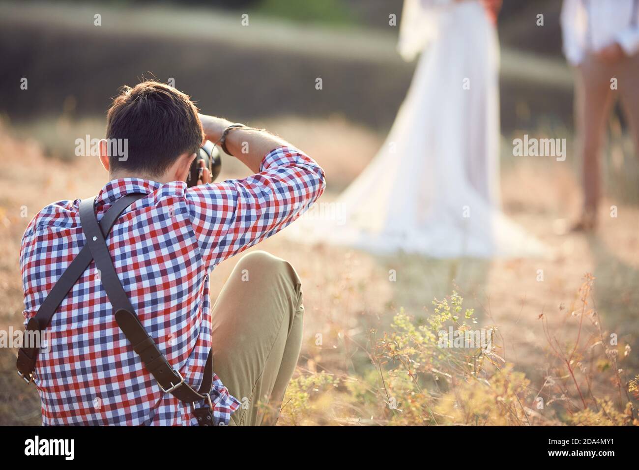 wedding professional photographer takes pictures of the bride and groom ...