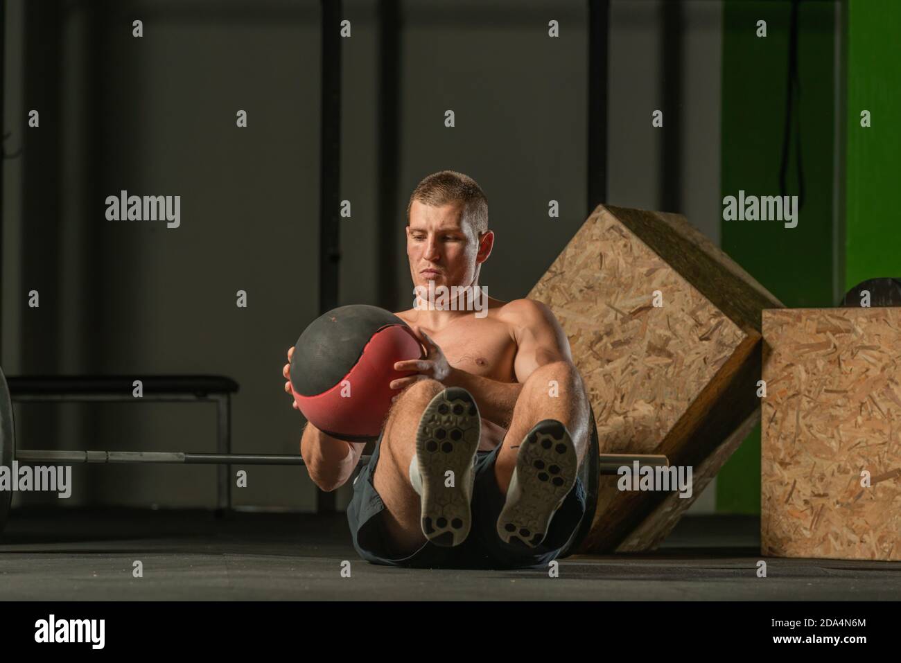 Close-up photo of a handsome bodybuilder working out seated using a ...