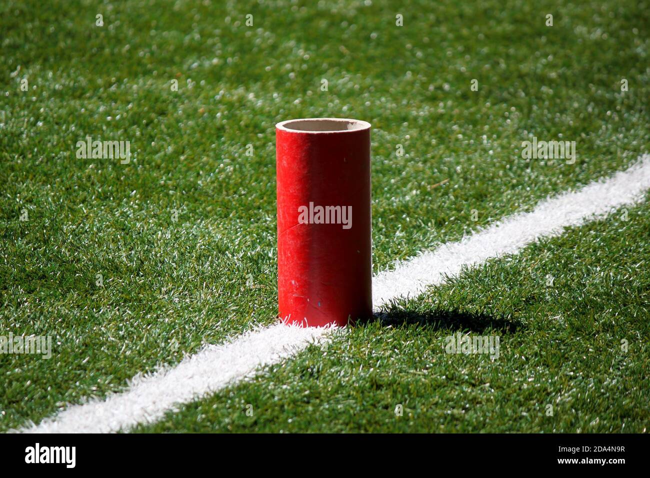 A hollow cylinder of red on a green field. The label for a child's ...