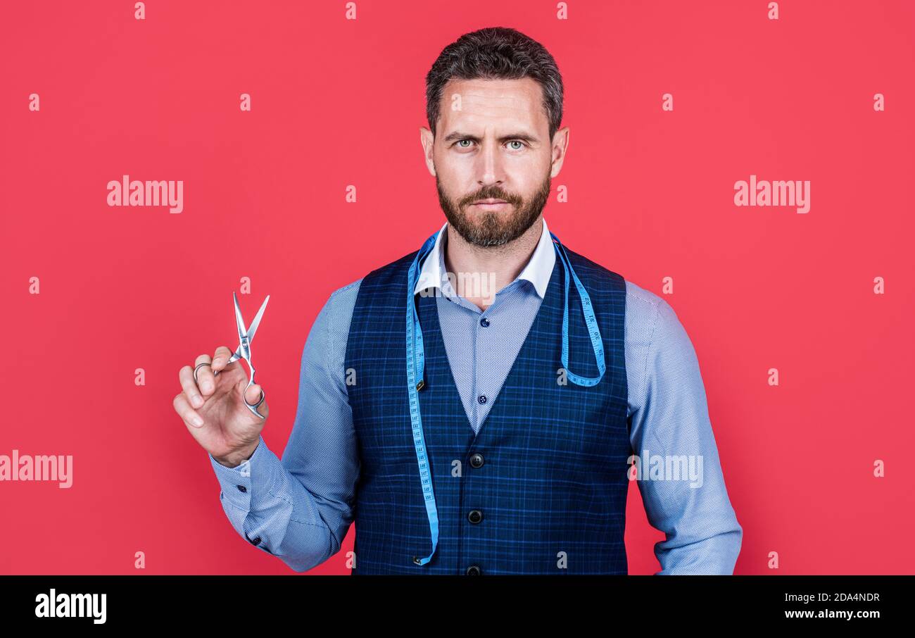 Tailor makes the man. Tailor with measure tape hold scissors red ...
