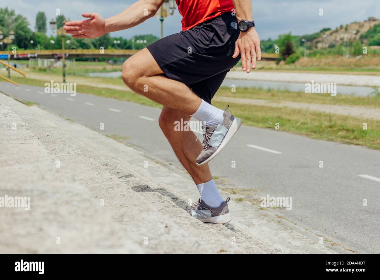 Fit male athlete performing stairs workout, running up climbing stairs ...