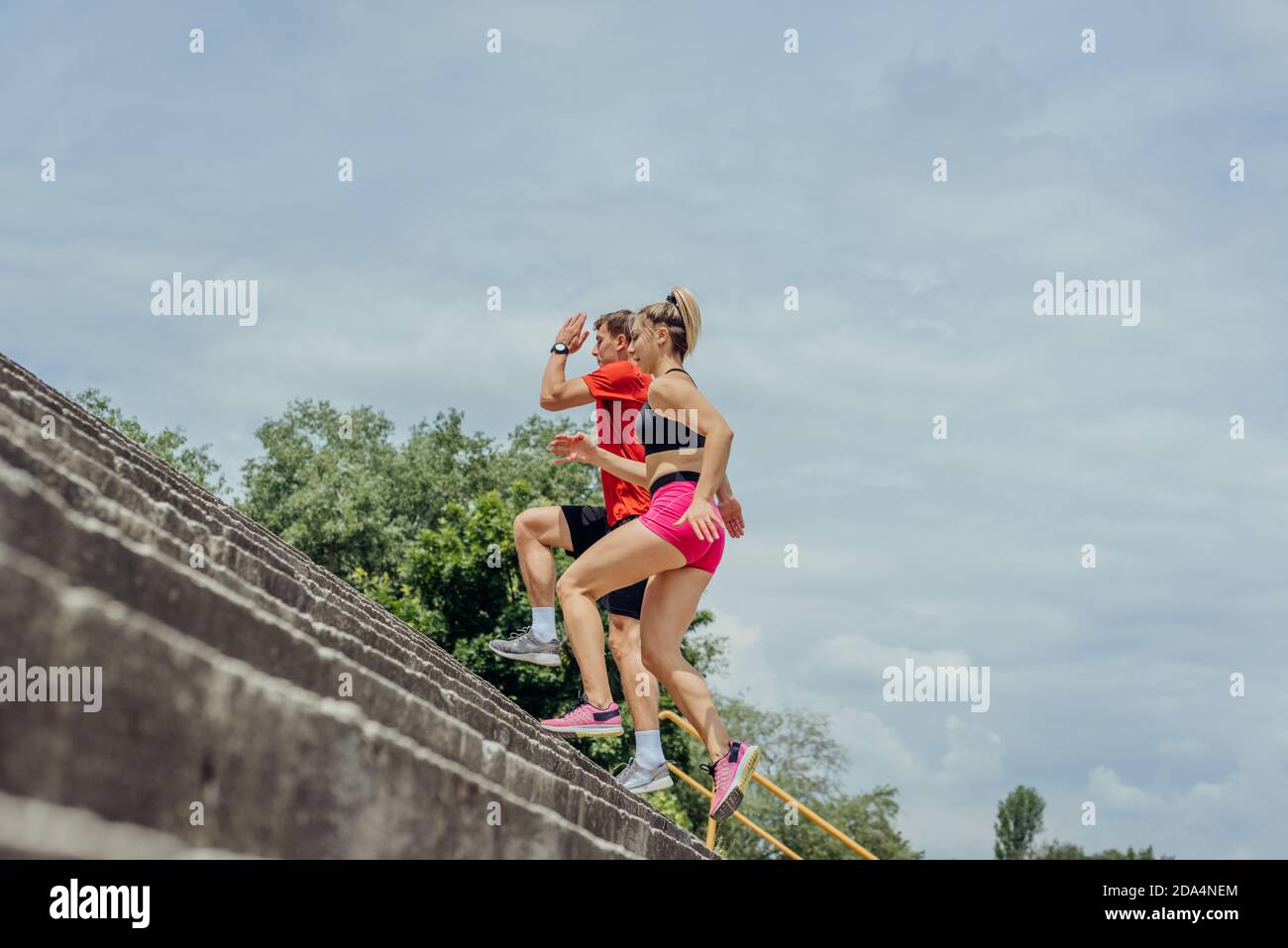 Healthy active couple exercising cardio and sprinting staircase in a ...