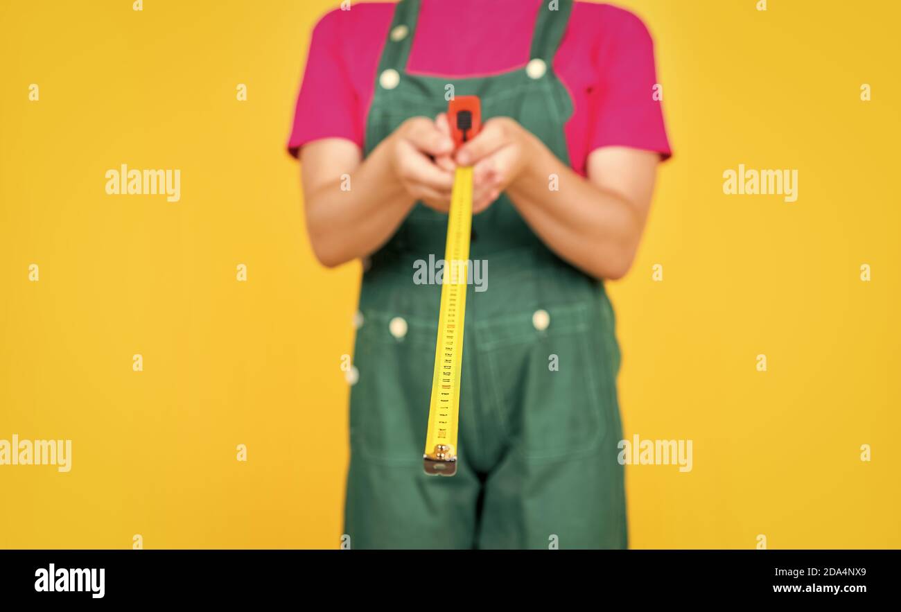 concept of repair. Little girl using a measuring tape. engineer. child ...